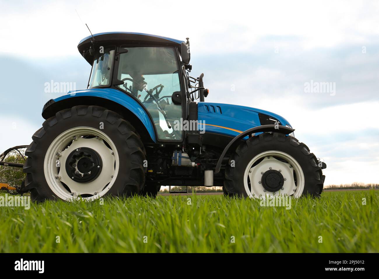Modern tractor in field on sunny day. Agricultural industry Stock Photo ...