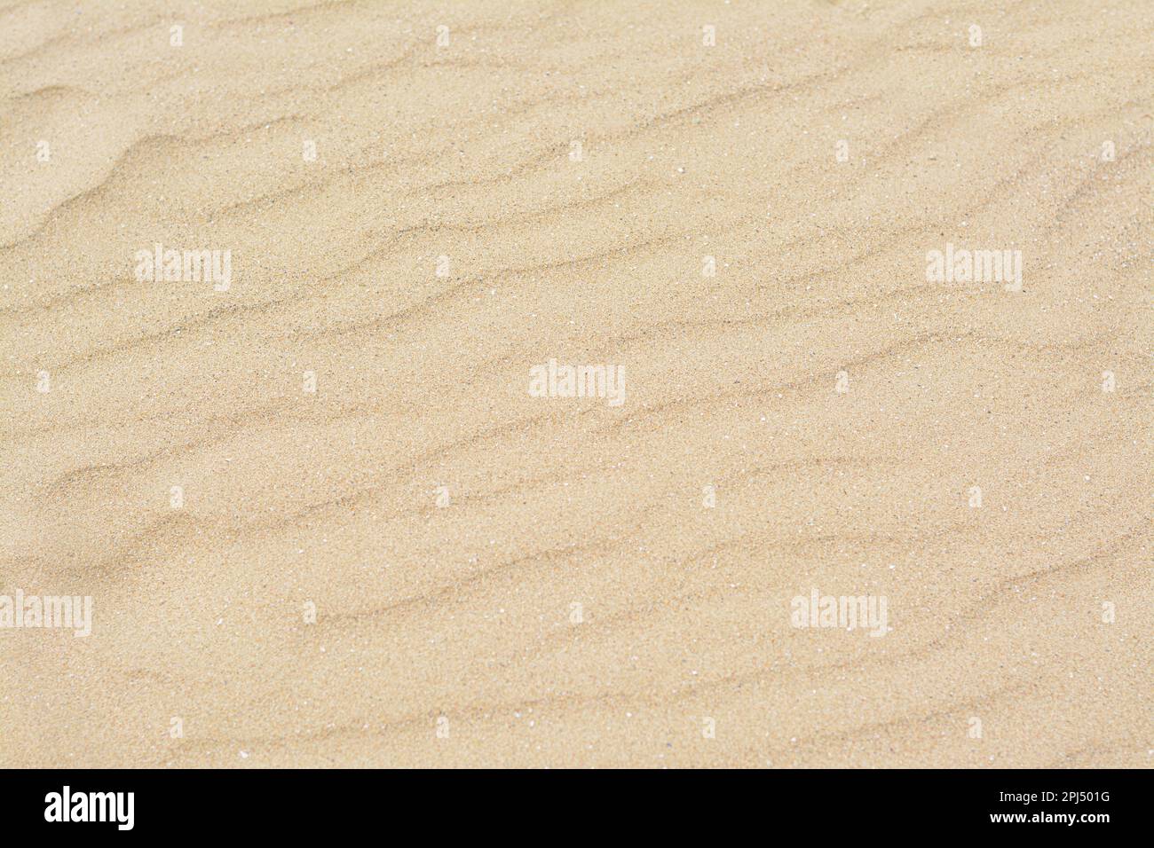Dry beach sand with wave pattern as background Stock Photo - Alamy