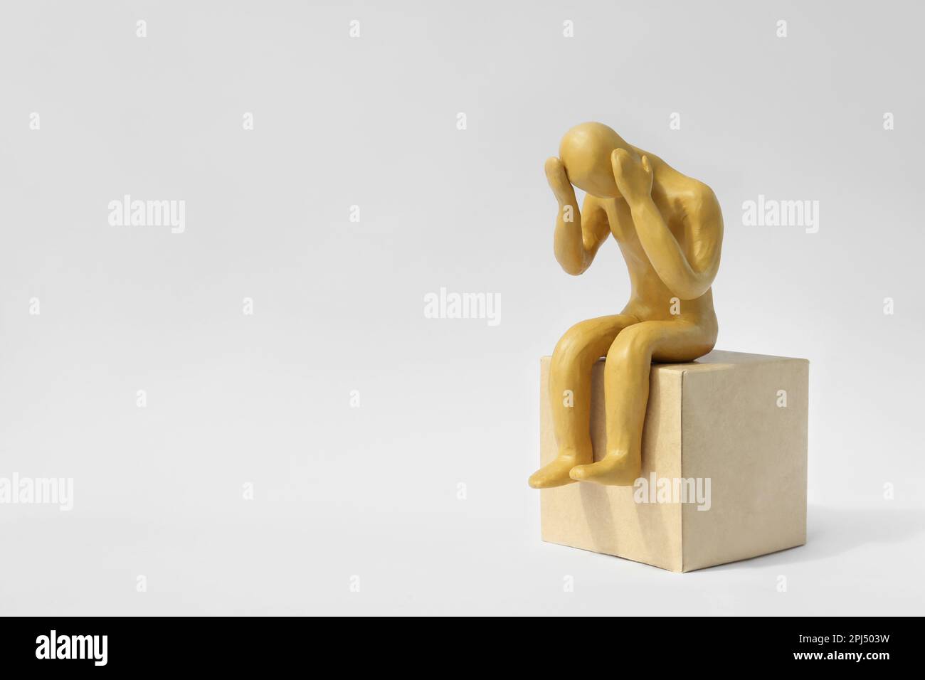 Plasticine figure of troubled human on white background. Space for text ...