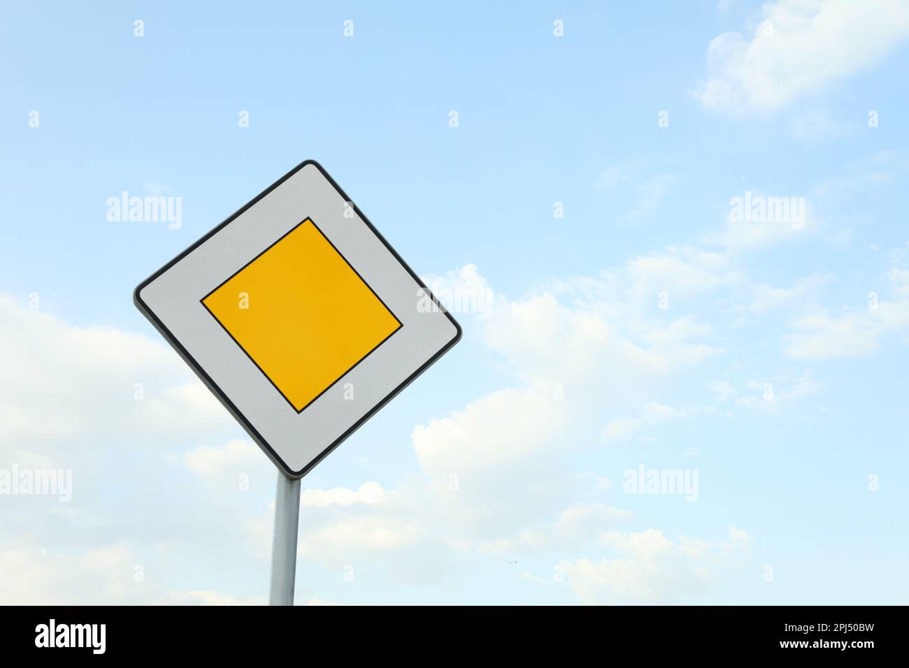 Traffic sign Priority Road against blue sky. Space for text Stock Photo ...