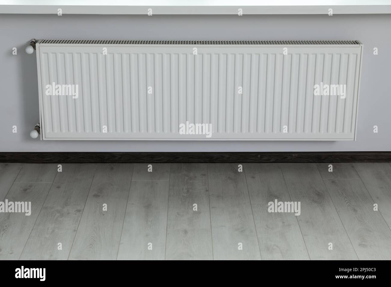 Modern radiator on white wall in office. Interior design Stock Photo ...