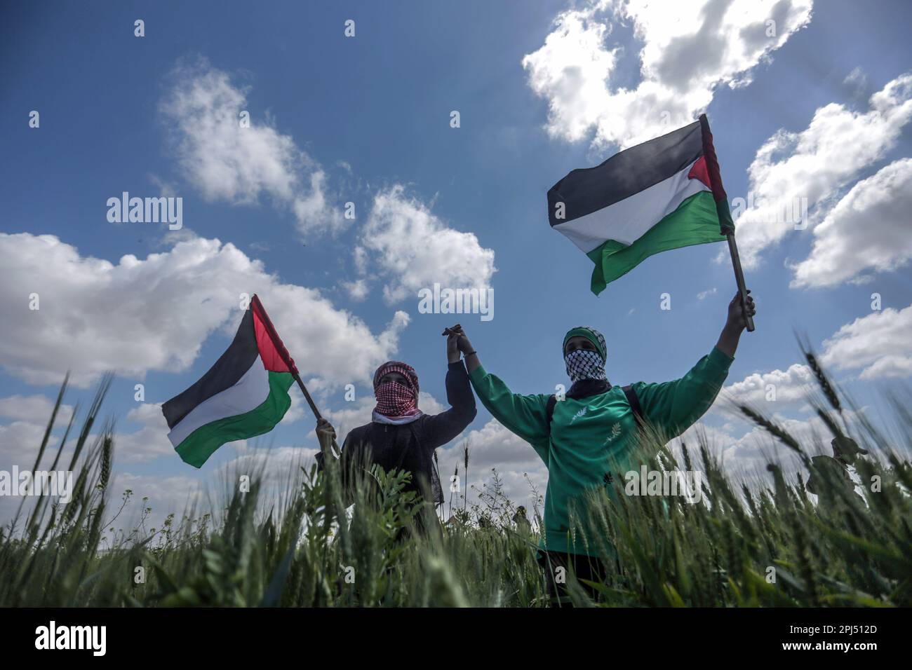 Palestinians hold flags during a protest marking 'Land Day' along the ...