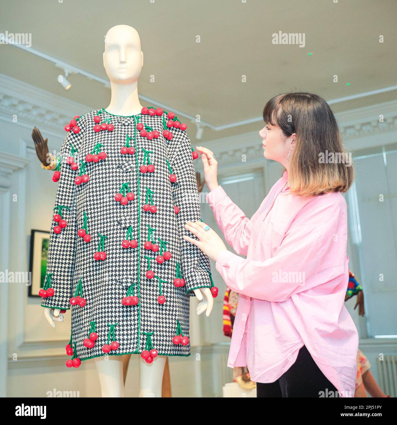 London, UK. 31st Mar, 2023. Gallery staff with the "Cherries Coat ...