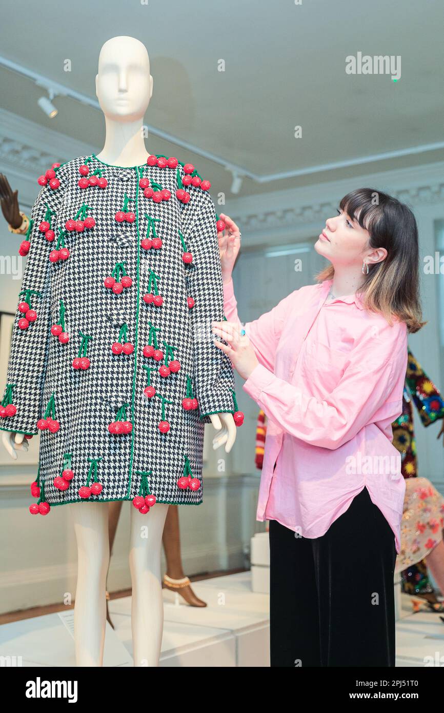 London, UK. 31st Mar, 2023. Gallery staff with the "Cherries Coat ...