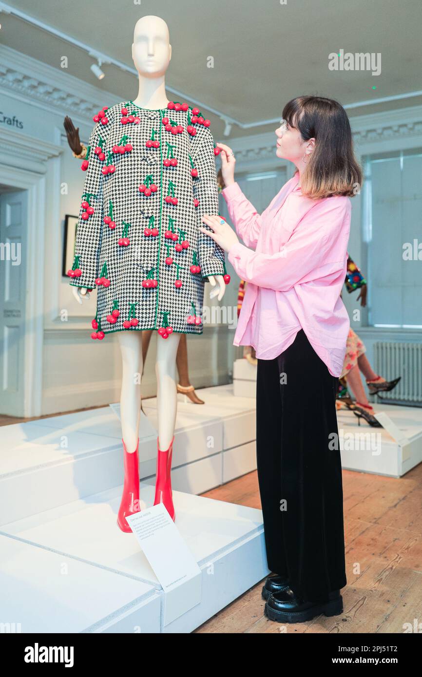 London, UK. 31st Mar, 2023. Gallery staff with the "Cherries Coat ...