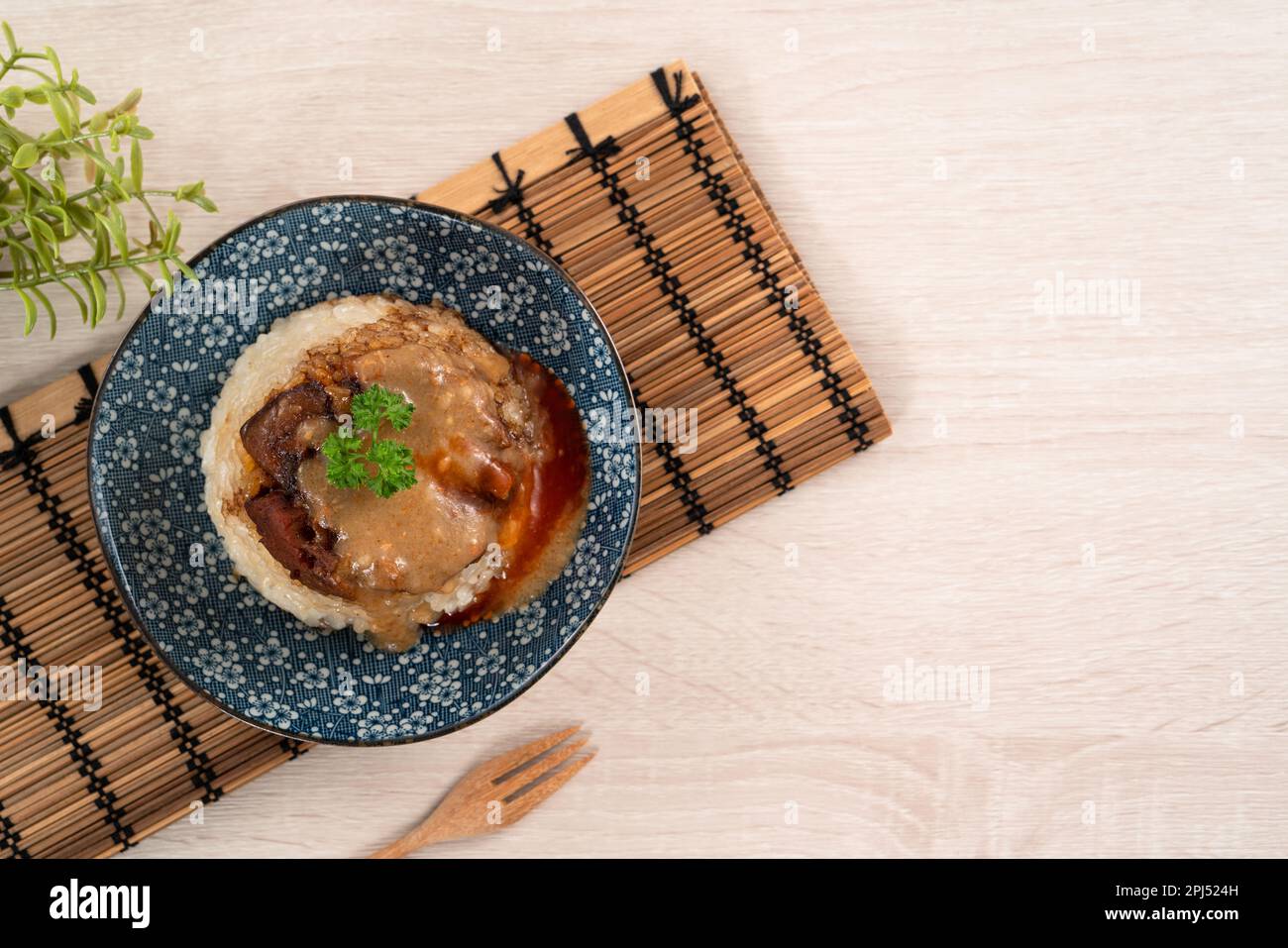 Migao, tube rice cake, rice pudding in a bowl topped with minced pork ...