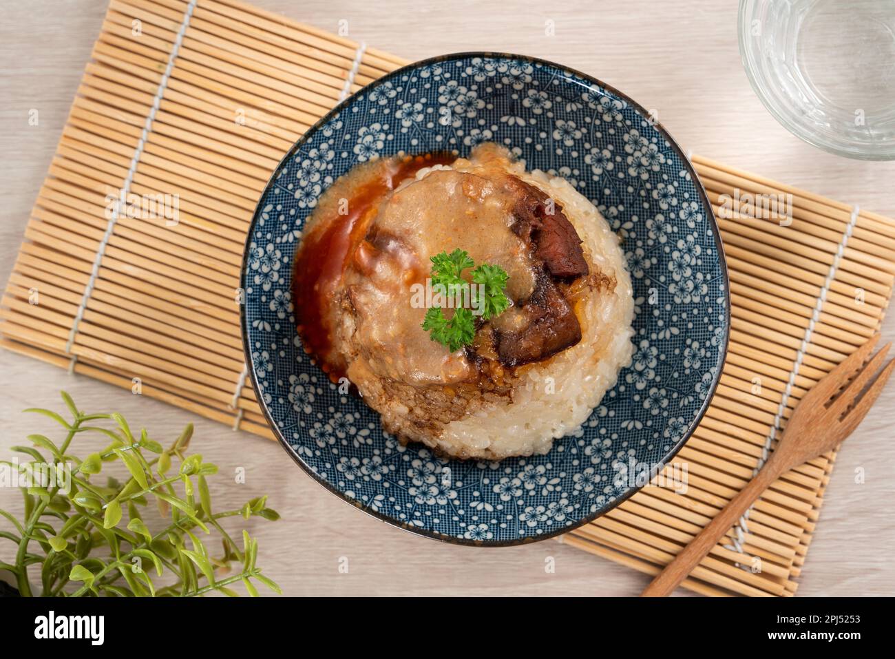 Migao, tube rice cake, rice pudding in a bowl topped with minced pork ...