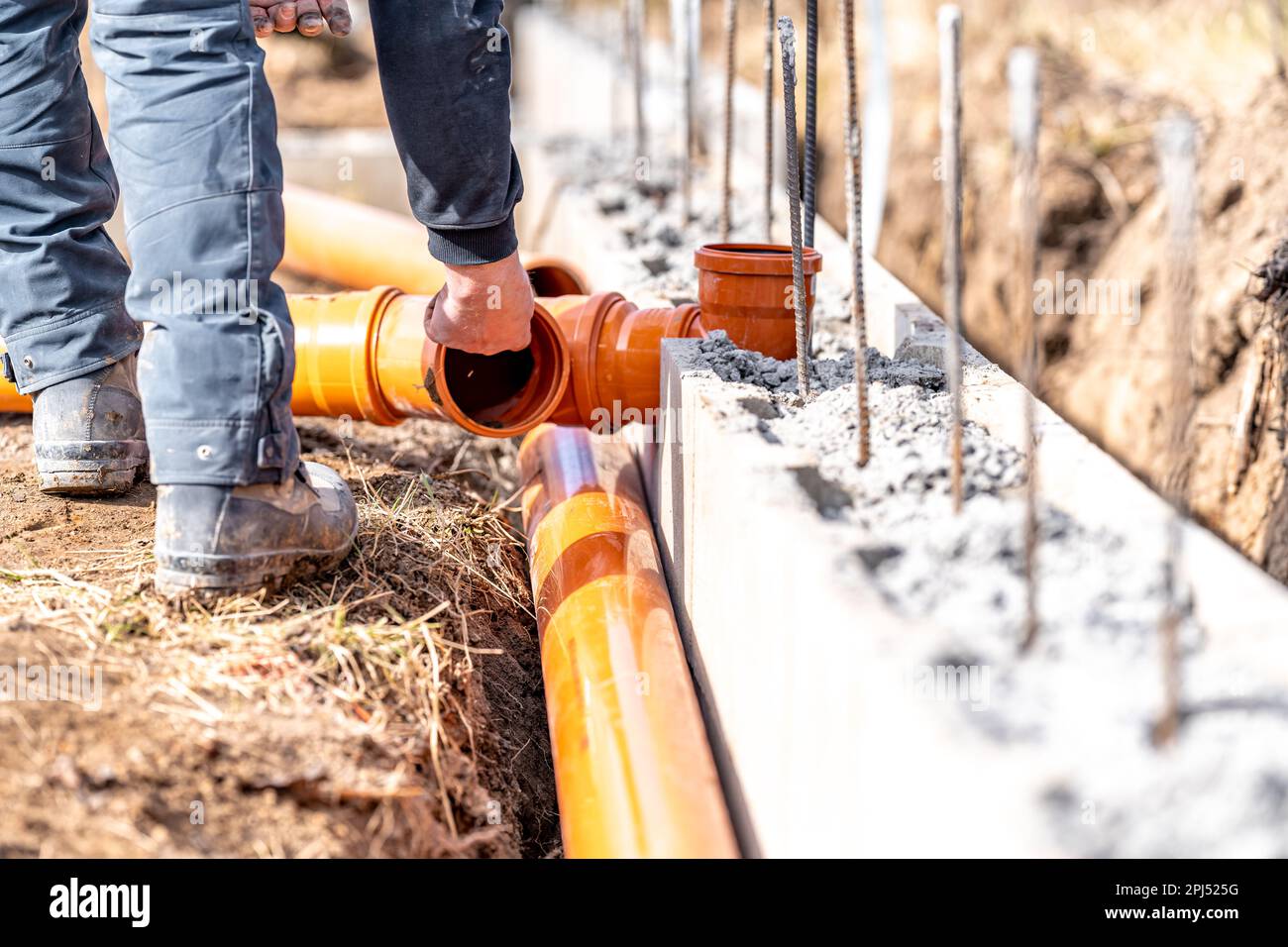 installation of a sewage plastic pipe during the construction of a ...