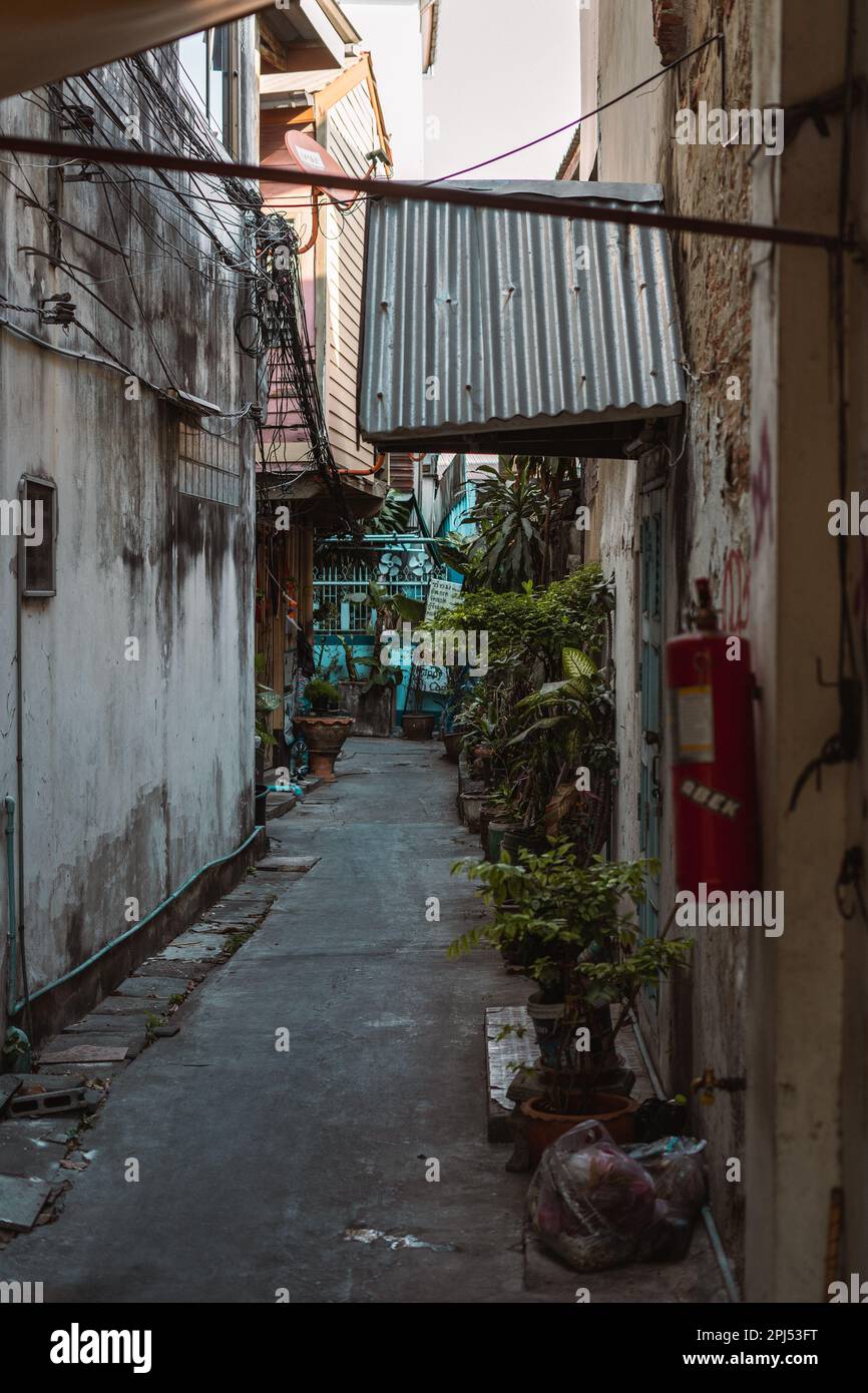 A vertical image of a narrow city street surrounded by tall buildings ...