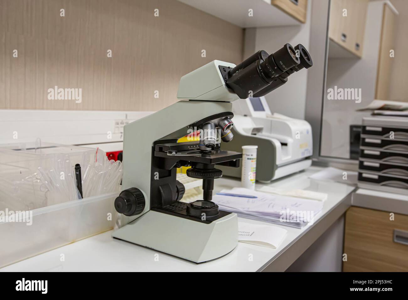 Microscope on table with chemical tube and glassware in laboratory ...