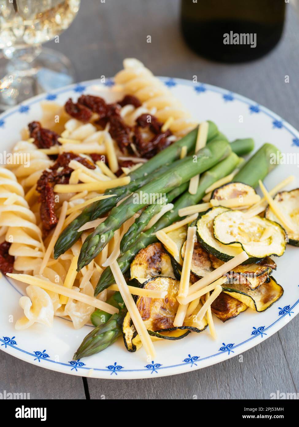Giant spiral pasta with green asparagus, grilled zucchini, sun-dried ...