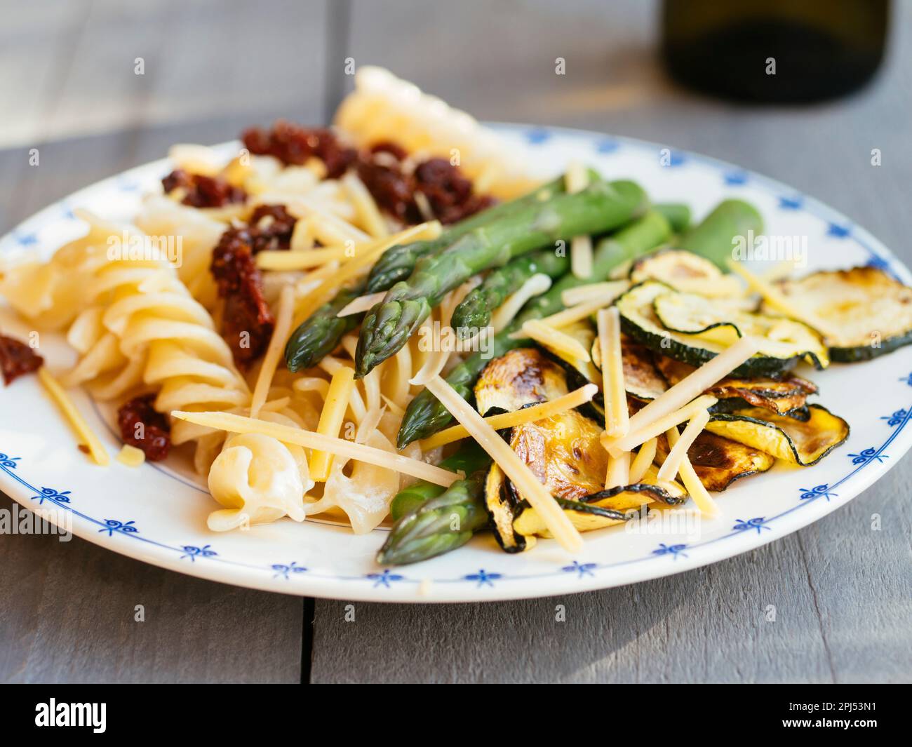 Giant spiral pasta with green asparagus, grilled zucchini, sun-dried ...
