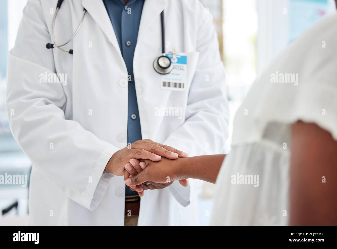 Support, hands and doctor comforting a patient after a diagnosis at a ...