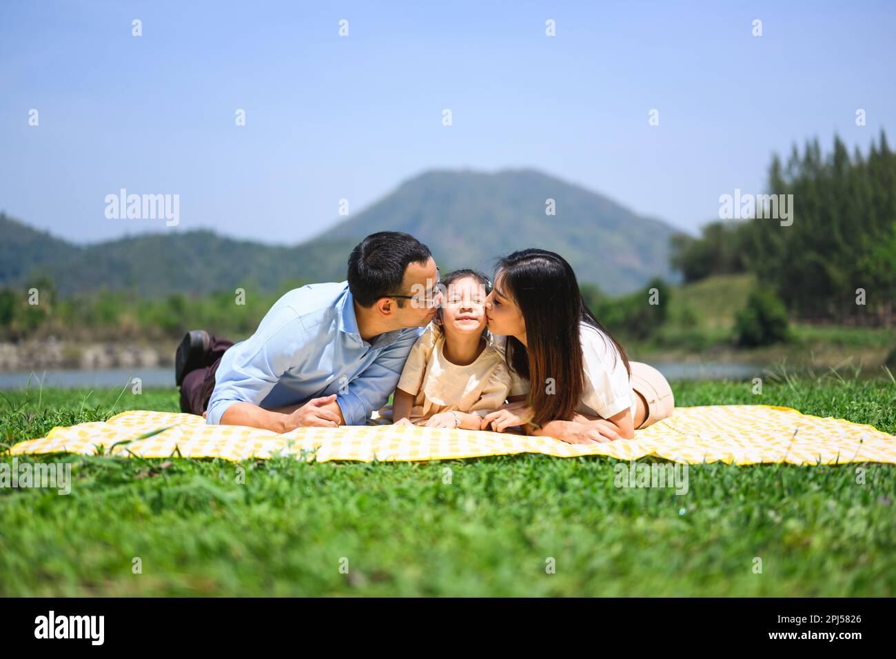 Happy family relaxing and playing outdoor together in park on weekend ...