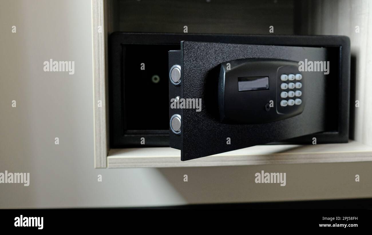 Metal safe box in the closet. Small narrow safe for keeping money or ...