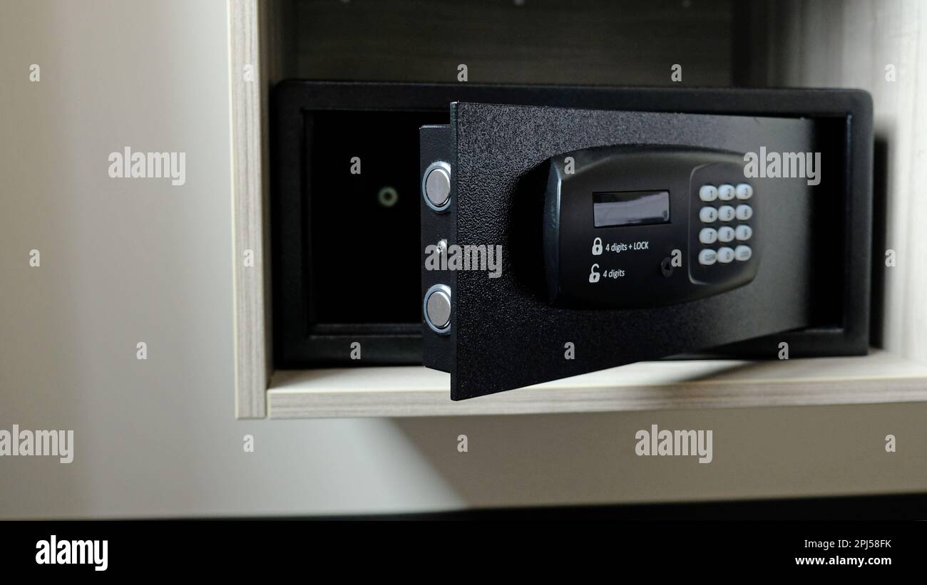 Metal safe box in the closet. Small narrow safe for keeping money or ...