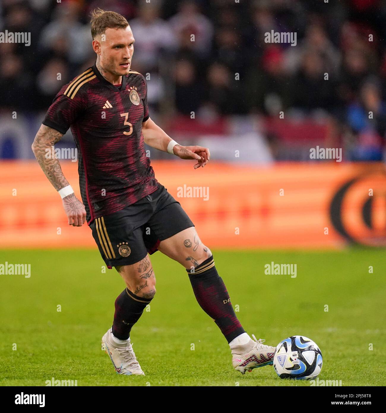 COLOGNE, GERMANY - MARCH 28: David Raum of Germany passes the ball ...