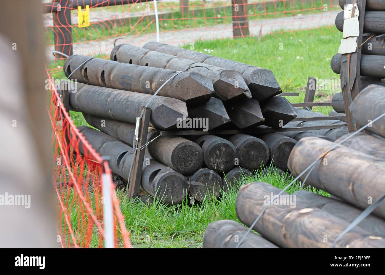 Pile of wooden poles for construction, selective focus Stock Photo - Alamy
