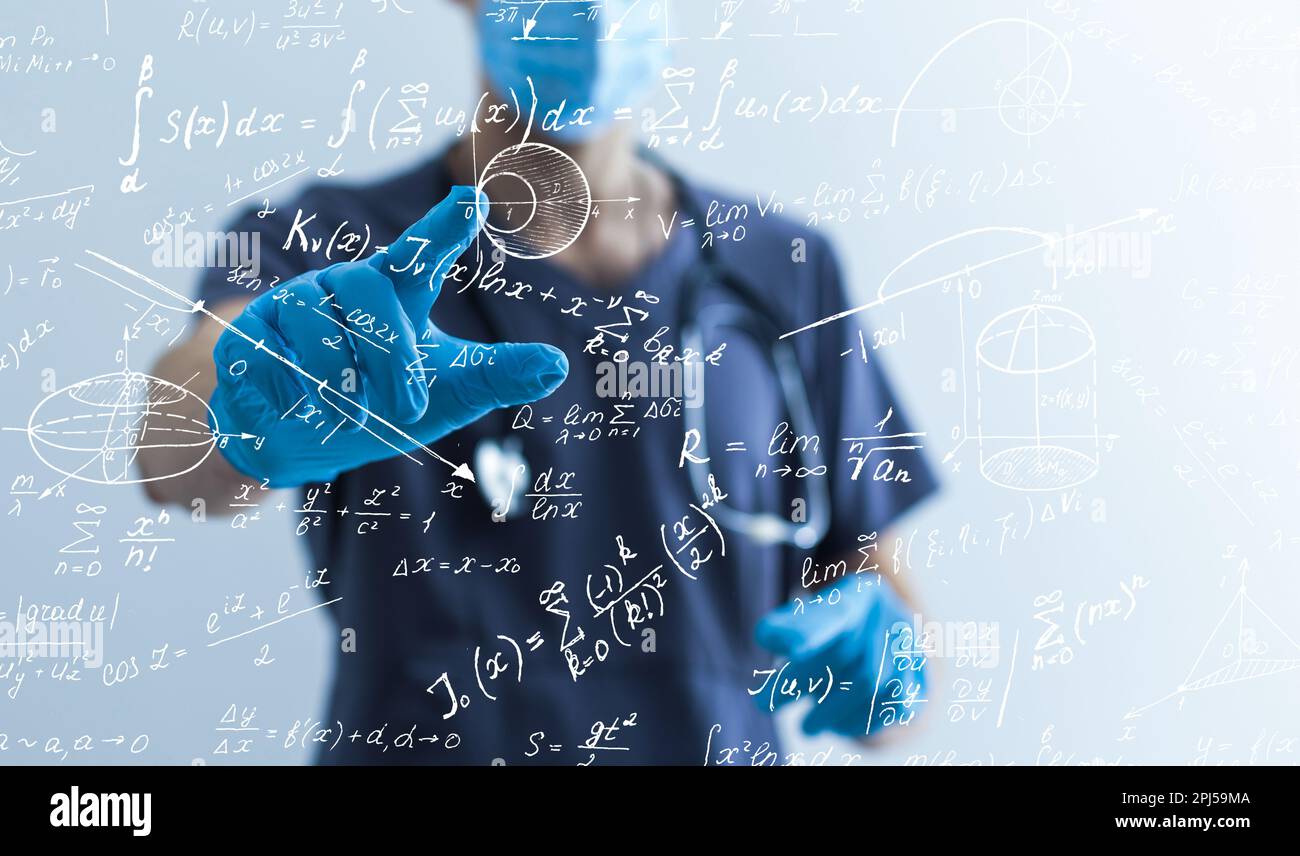 Quantitative analyst is drawing different math formulas on the glass ...