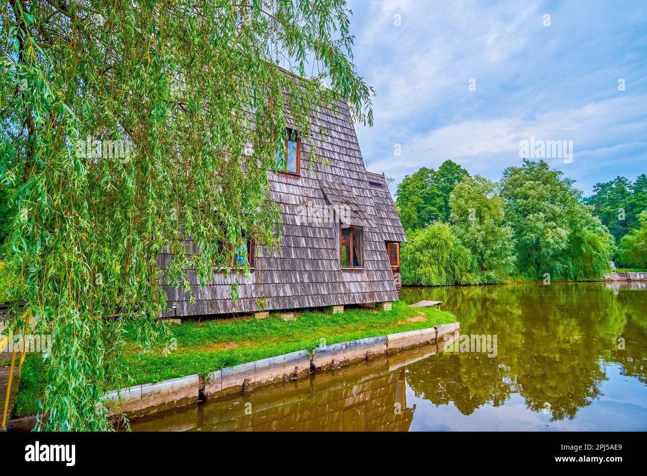 Wooden hunter's house on the islet in small forest lake, Styr hunting ...