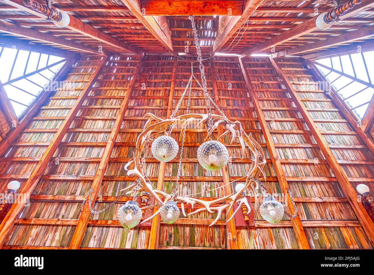 The scenic chandelier made from horns and the wooden roof of hunter's ...