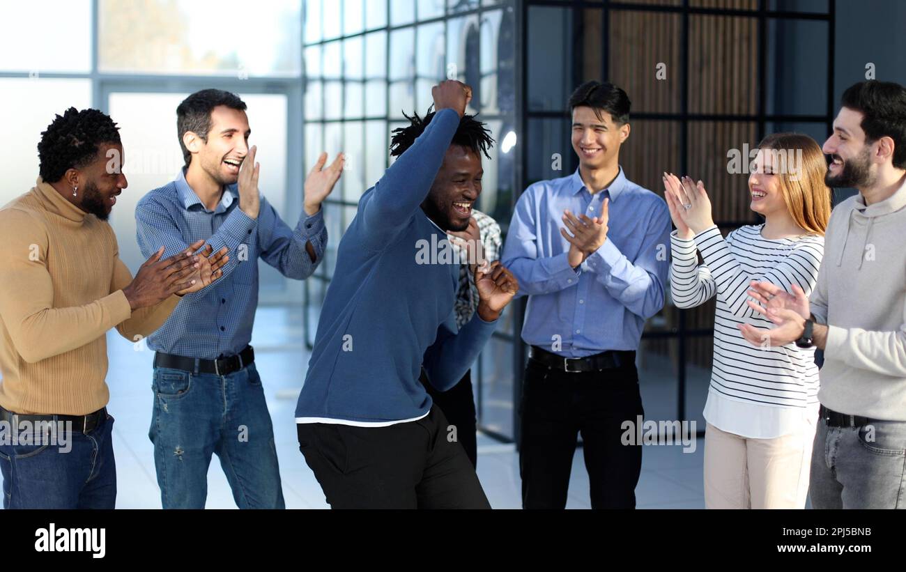 happy excited millennial employees shouting for joy, raising hands for ...