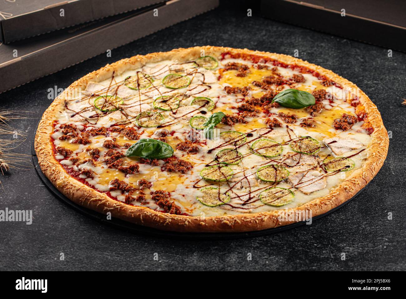 Big assorted pizza with variety of toppings Stock Photo - Alamy