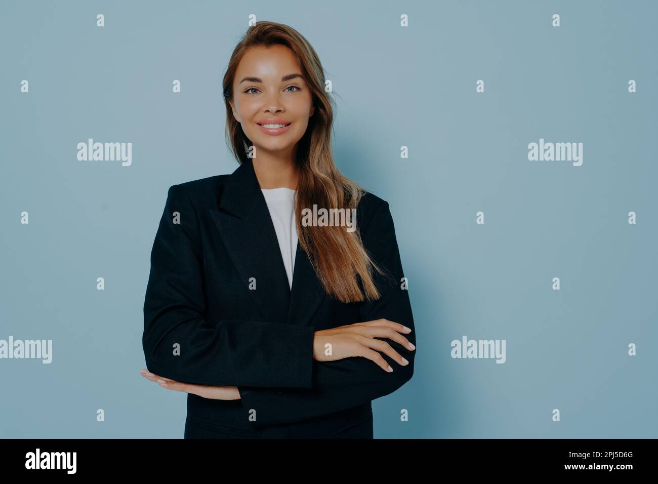 Studio shot of determined beautiful businesswoman in formal black suit ...