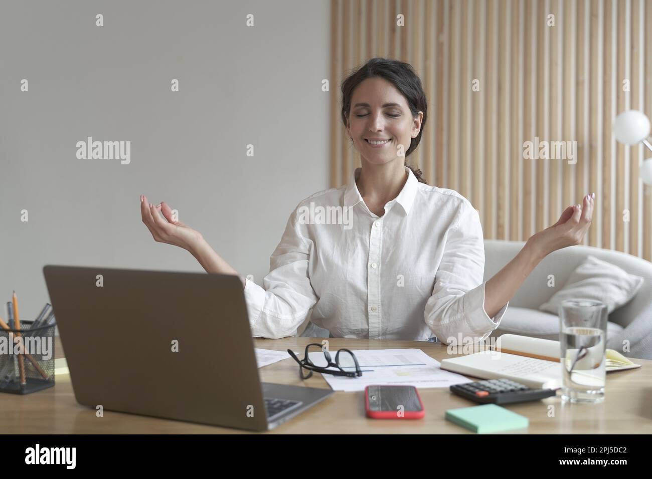 Young mindful woman meditating home hi-res stock photography and images - Alamy