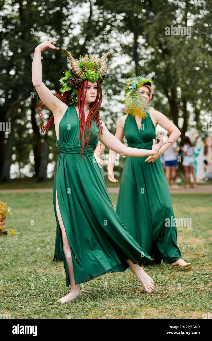 Svetlogorsk, Russia - 2022.08.13 - Two girls dryads dancing on green ...
