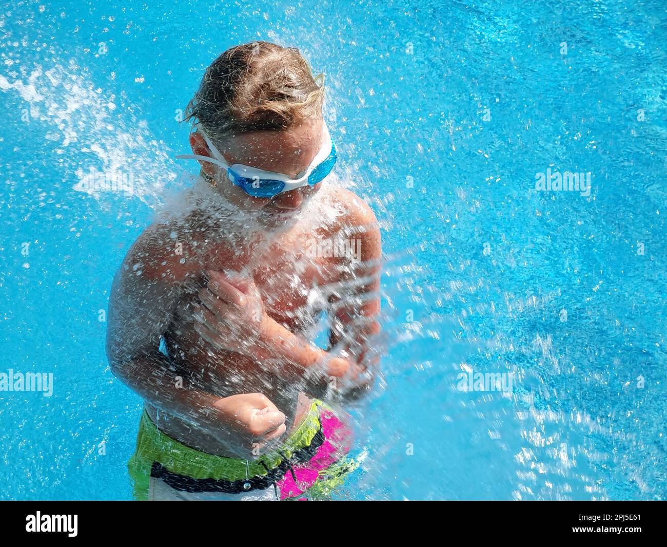 Teenage fun in swimming pool with splashing water Stock Photo - Alamy