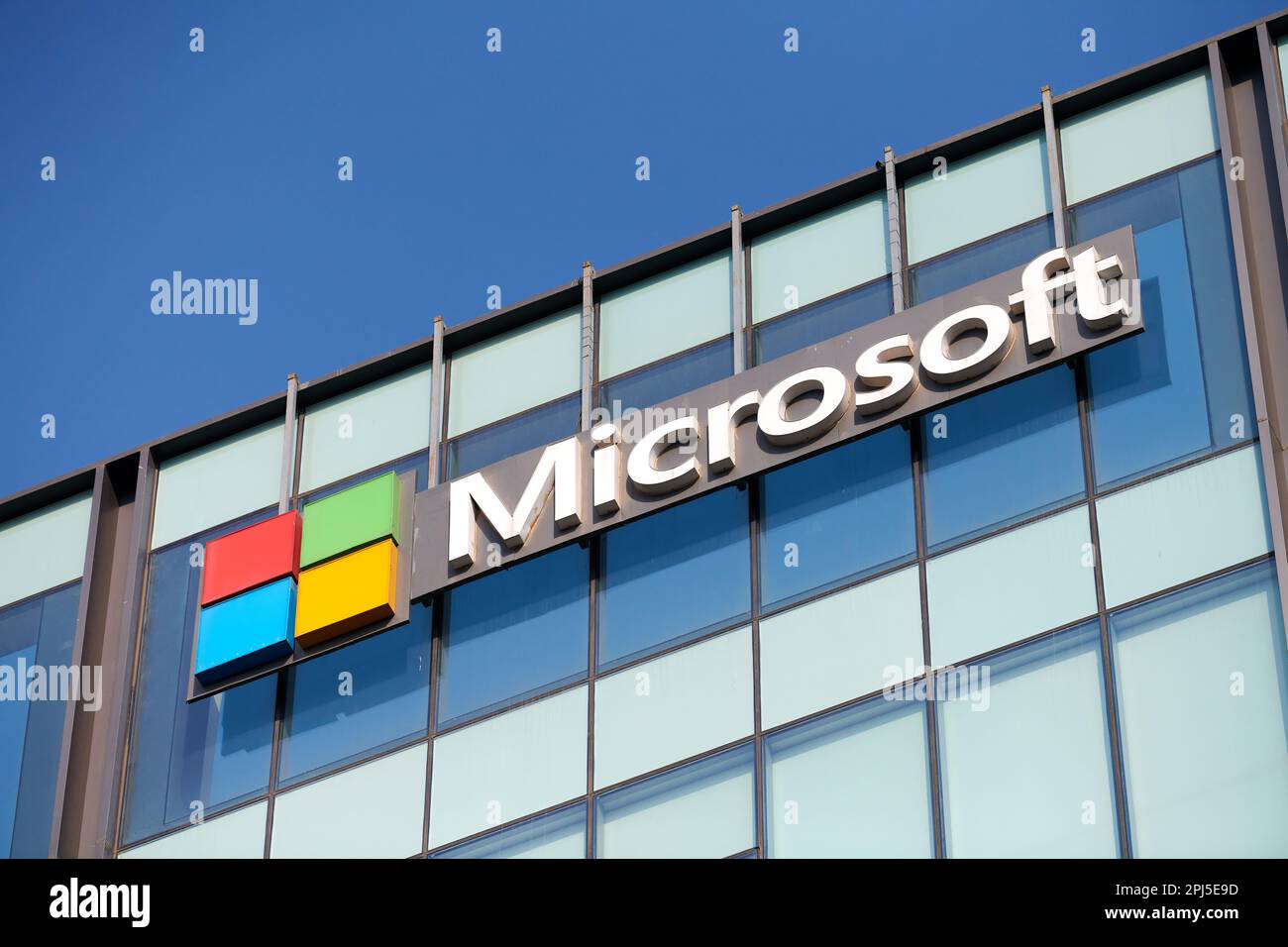 New Delhi - 08.12.2022 - Microsoft corporation brand logo on high rise glass building exterior ...