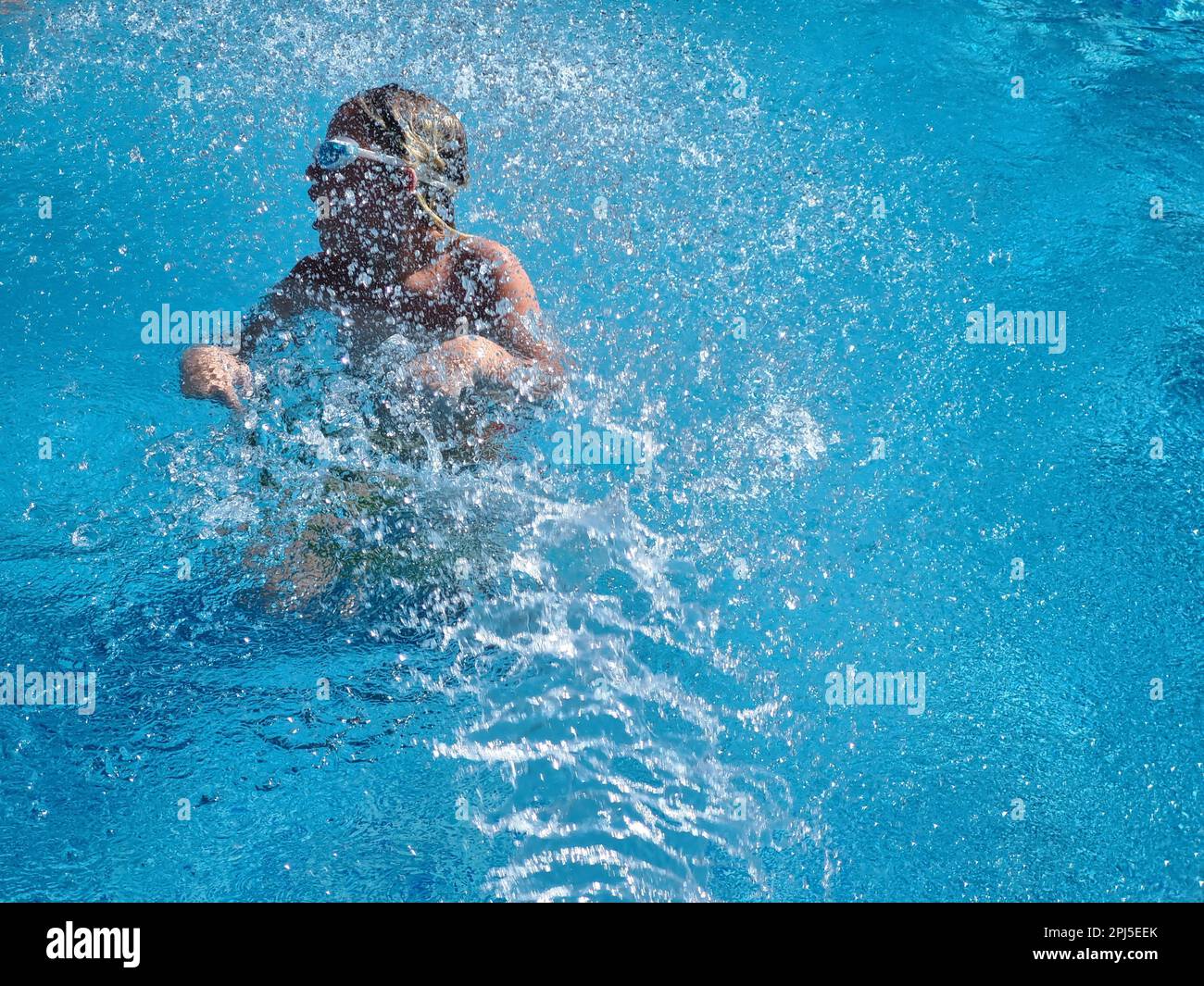 Teenage fun in swimming pool with splashing water Stock Photo - Alamy