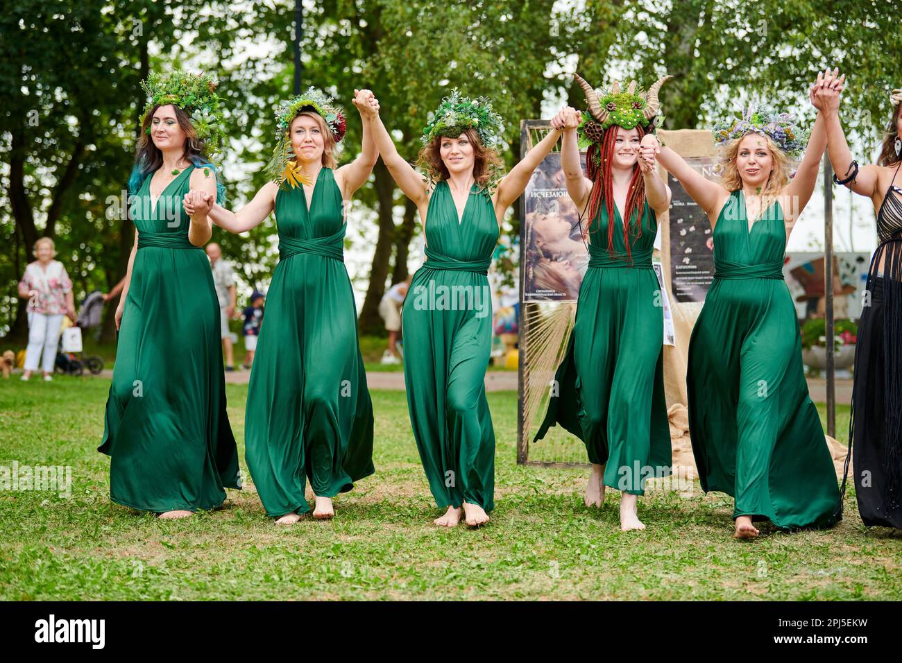 Svetlogorsk, Russia - 2022.08.13 - Dancing girls dryads on green lawn ...