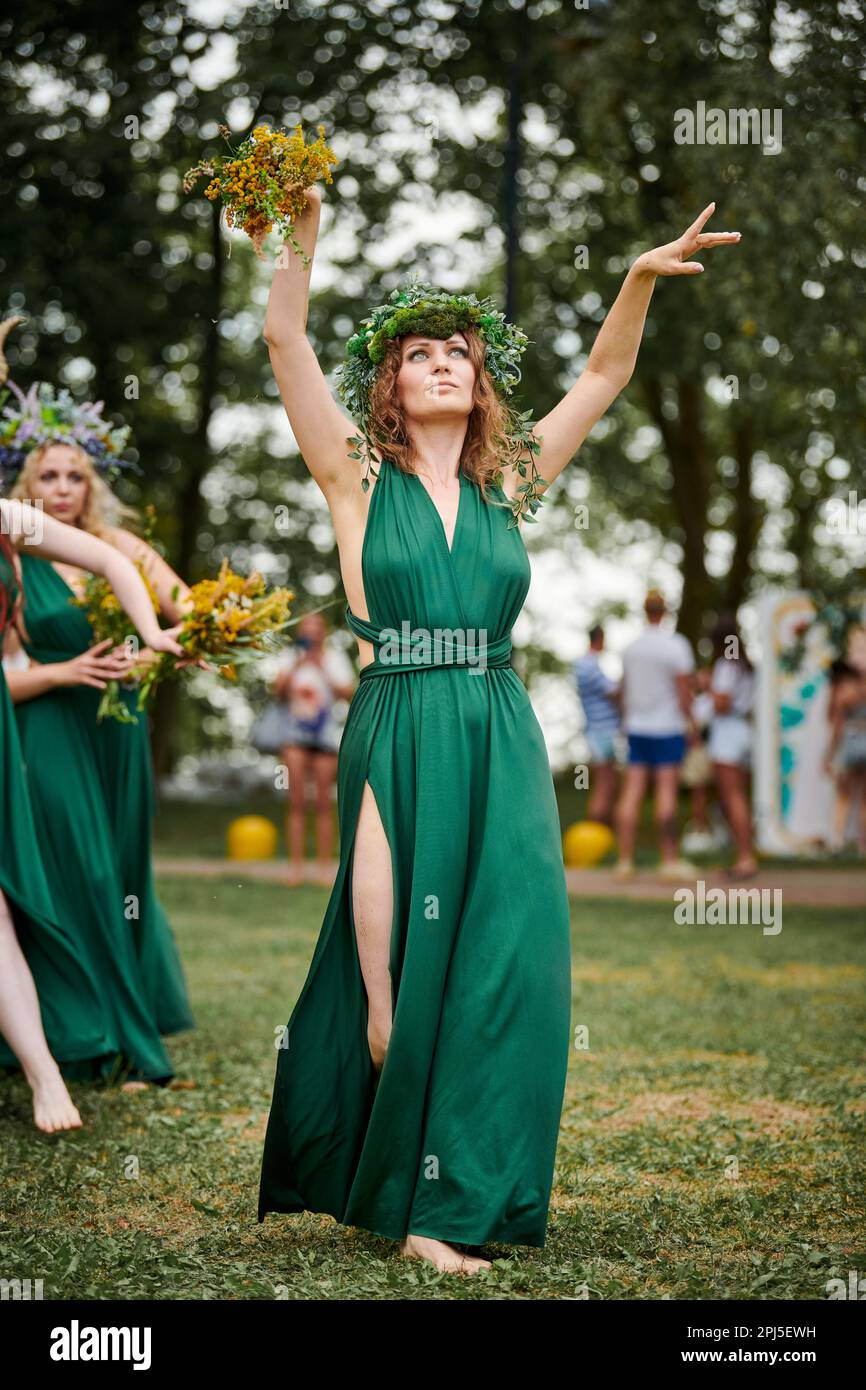 Svetlogorsk, Russia - 2022.08.13 - Dancing girls dryads on green lawn ...