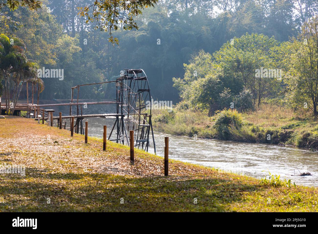 Traditional water wheel next to the river in Pai, Mae Hong Son district ...