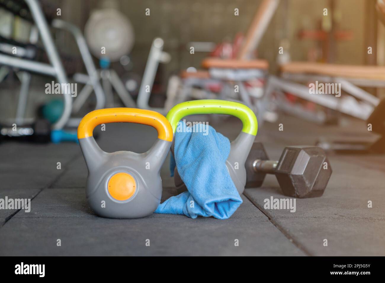 Kettlebell and dump bell weights at a fitness club Stock Photo - Alamy