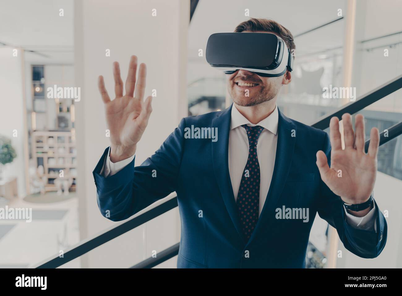 Young excited man office worker using virtual reality simulator at work ...