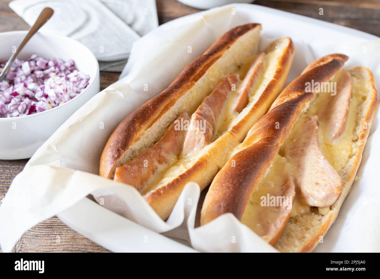 Sausage sandwich with german oven baked, boiled sausages, melted cheese ...