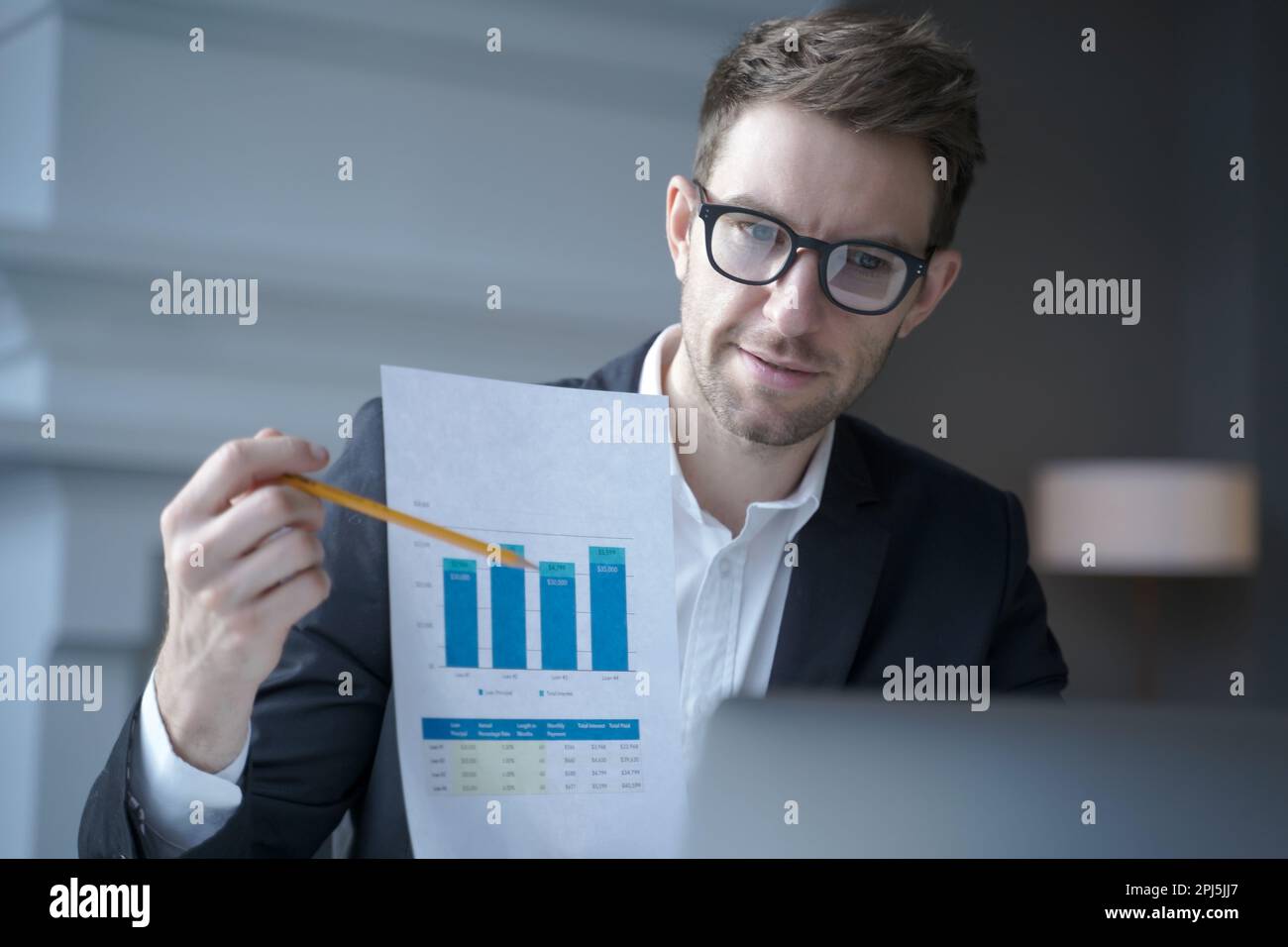 Successful Austrian CEO male in formal suit pointing at charts and ...