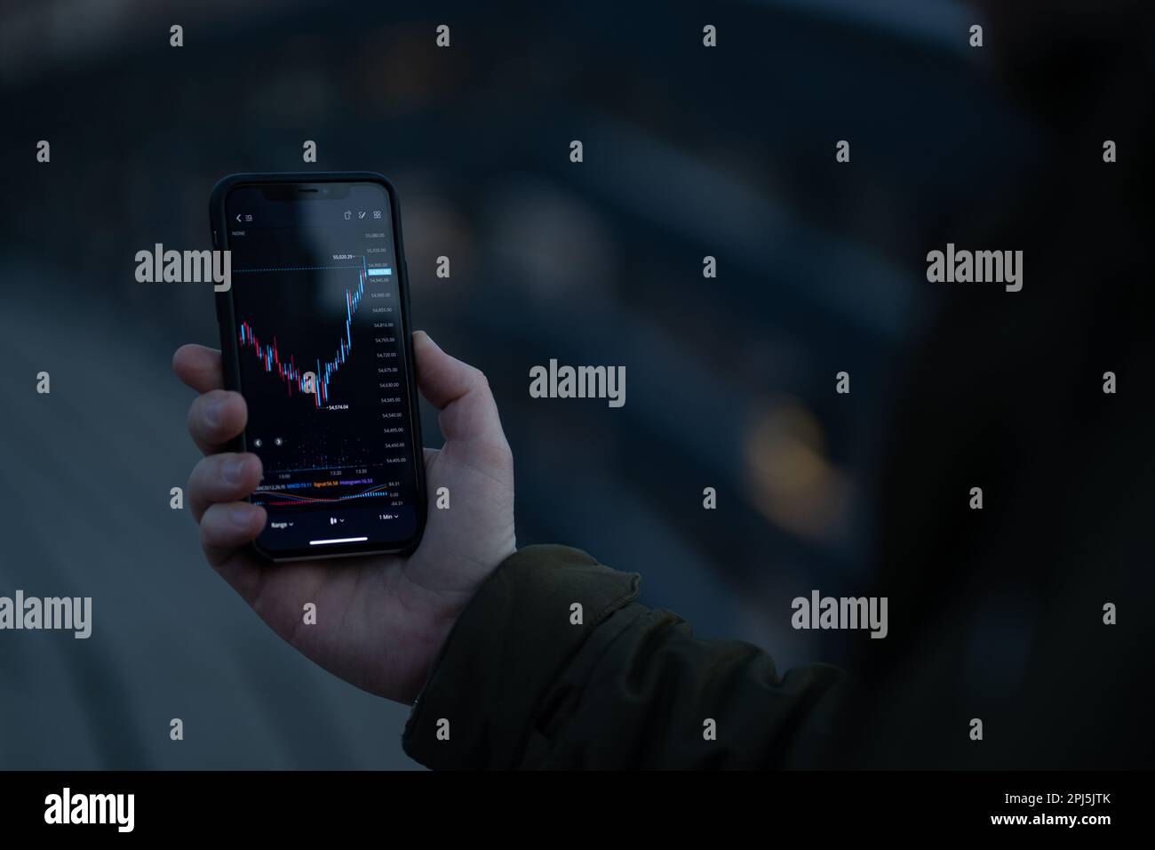 Male investor using stock trading app on smartphone, trader analyzing ...