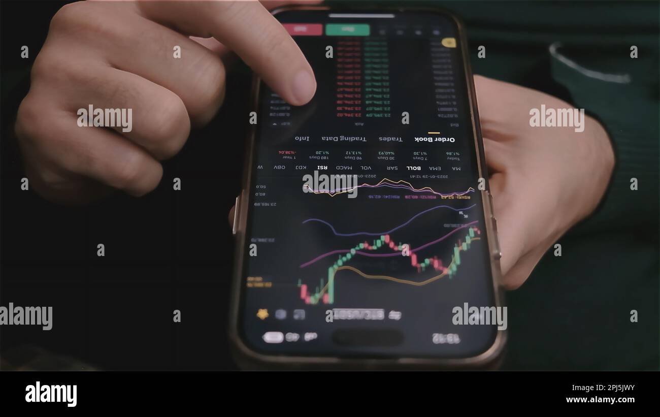 close up smartphone with stock market graph on touch screen with hands ...