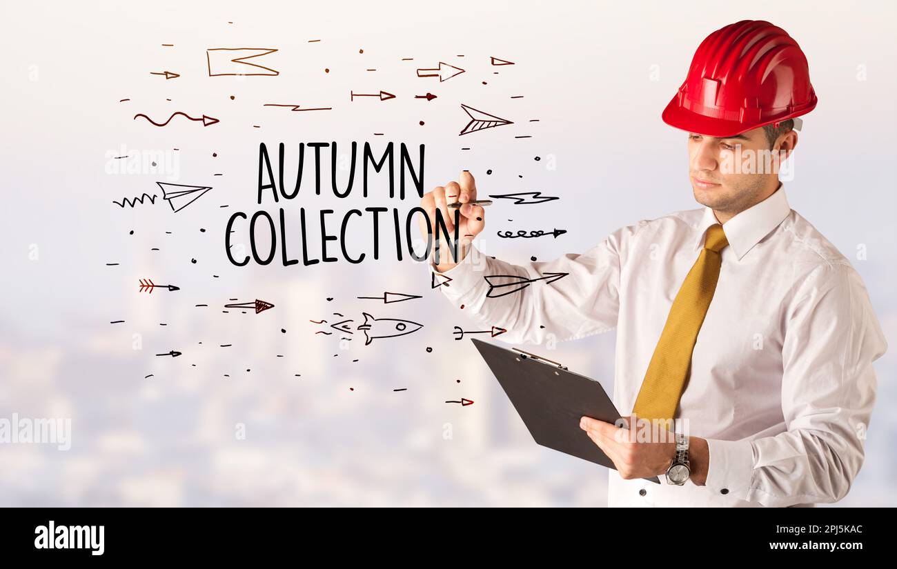 Young businessman with helmet drawing sale sign Stock Photo - Alamy