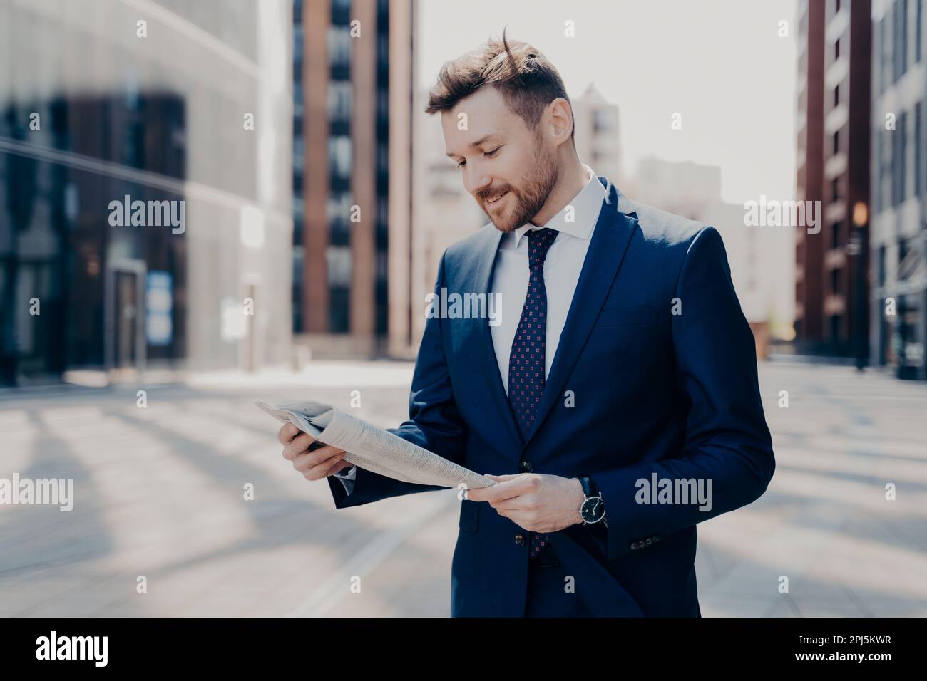 Confident business owner dressed in blue suit feeling delighted after ...