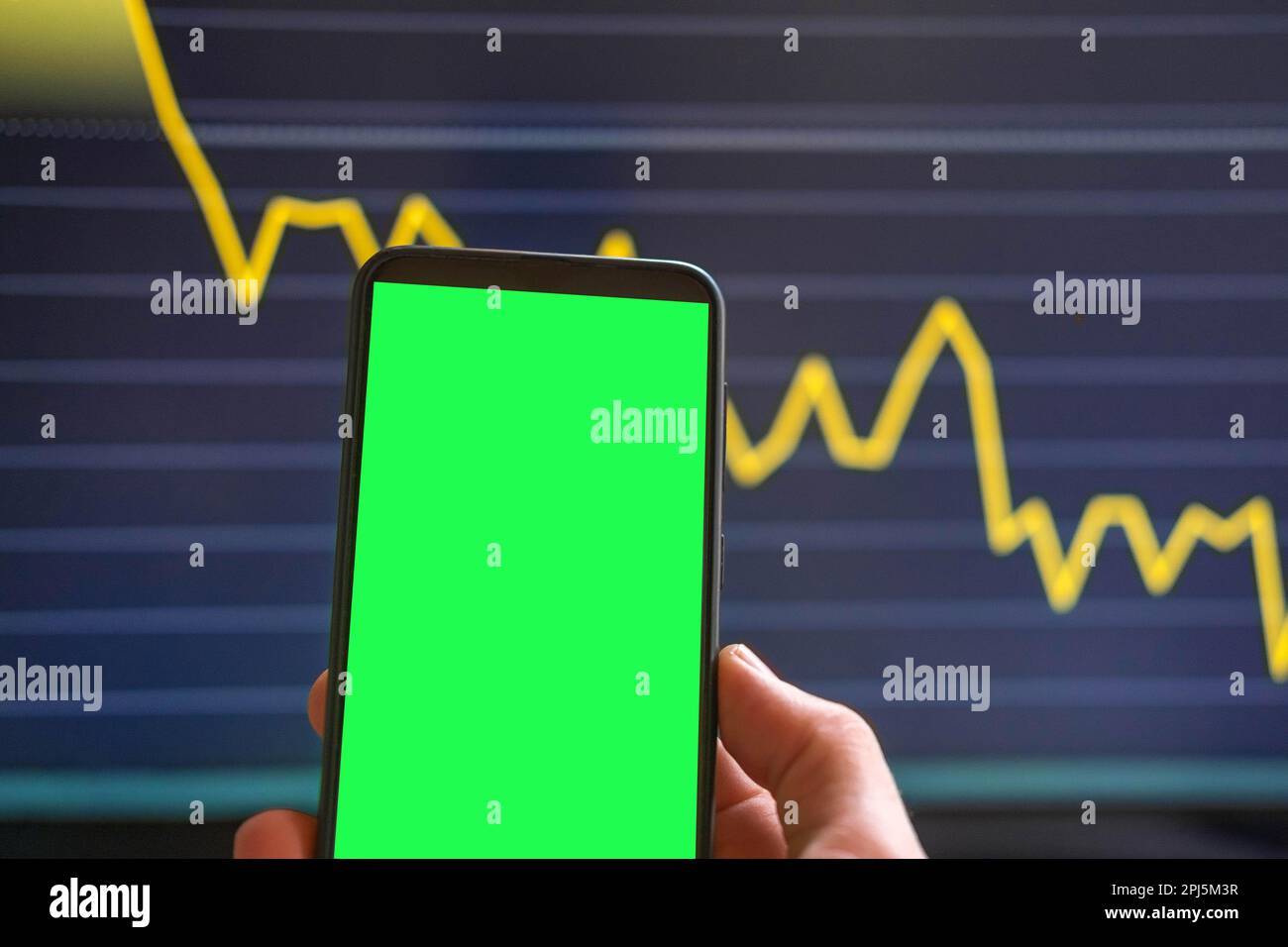 Black phone with blank mockup screen on rising stock graph. Closeup ...