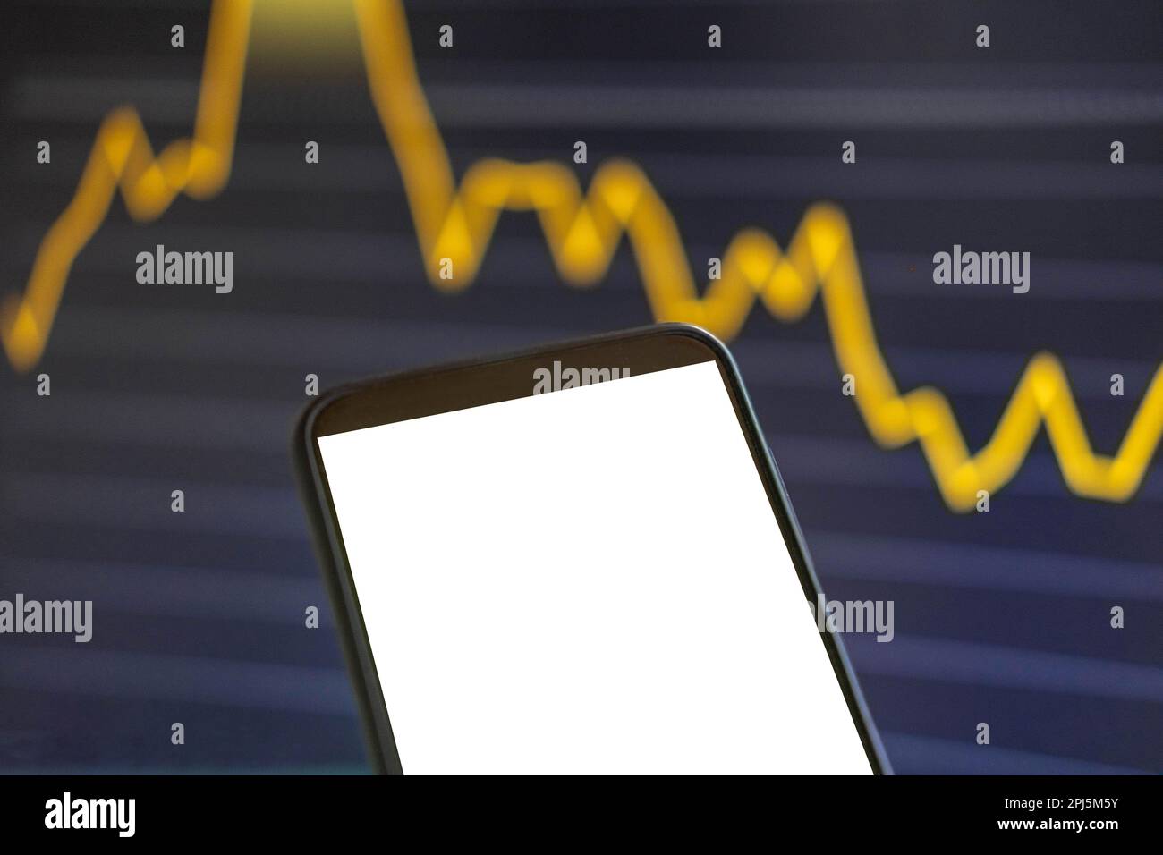 Black phone with blank mockup screen on rising stock graph. Closeup ...