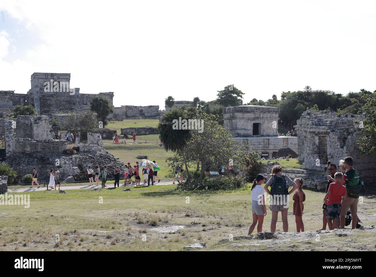 Tourists visiting Tulum ruins with El Castillo in the background, Tulum ...