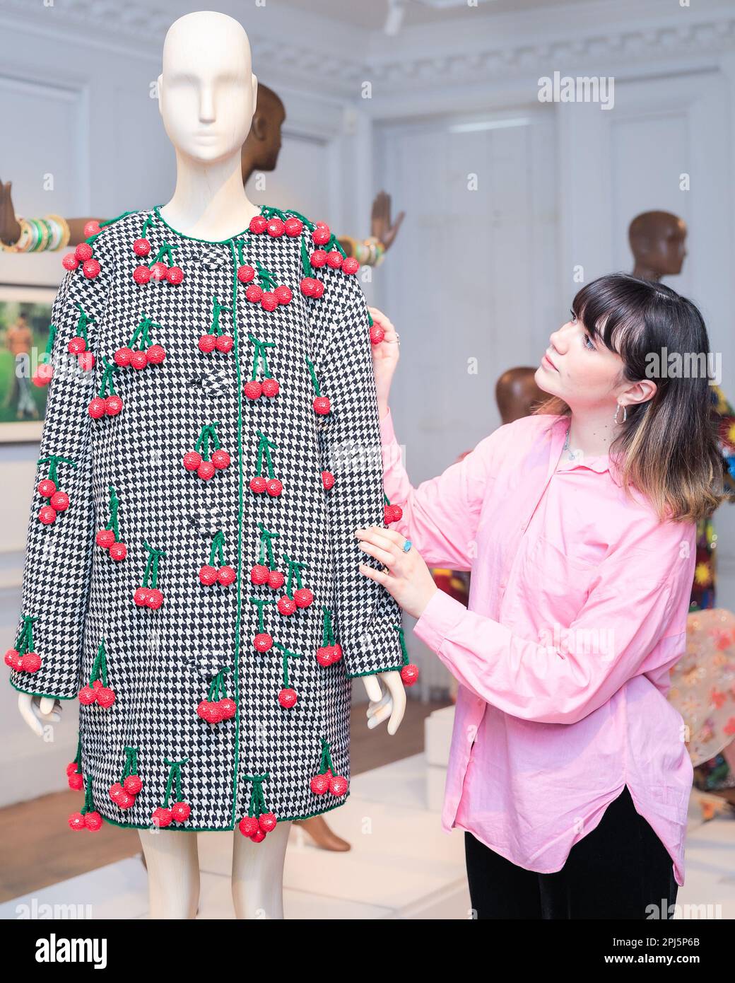 London, UK. 31st Mar, 2023. Gallery staff with the "Cherries Coat ...