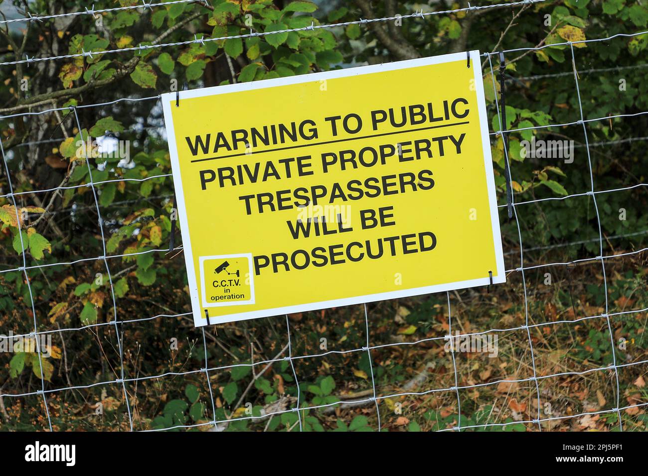 A sign saying 'Warning to public, private property, trespassers will be ...