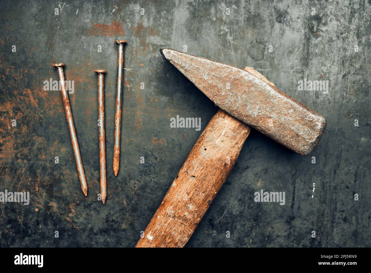Hammer and nails on steel surface. Tools for maintenance. Hardware ...